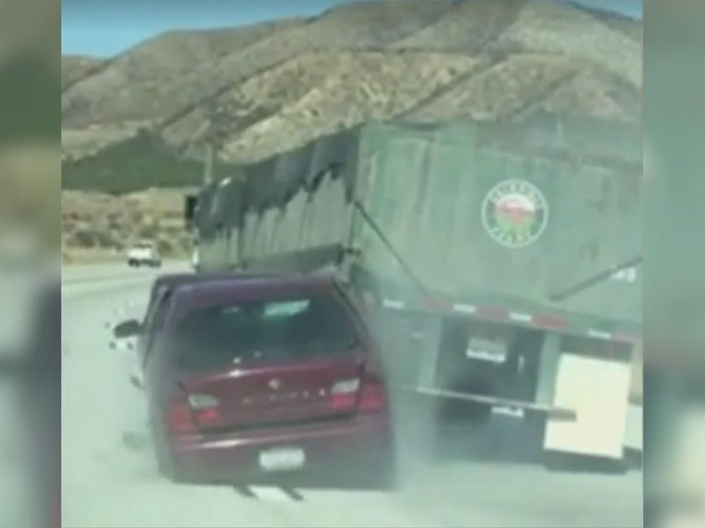 Car gets dragged along California freeway as driver waves for help ...