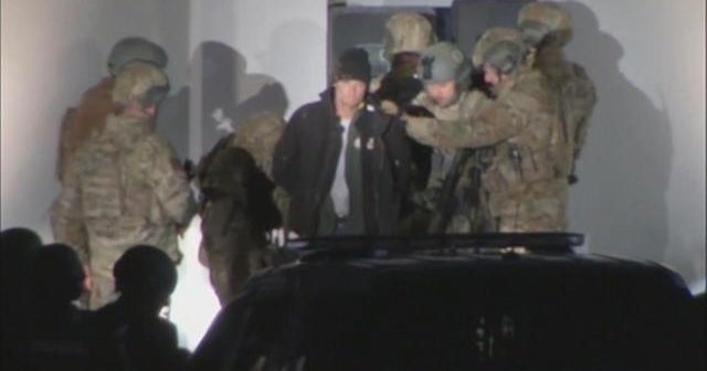 Alleged bank robber who held a woman hostage surrenders to police after ...